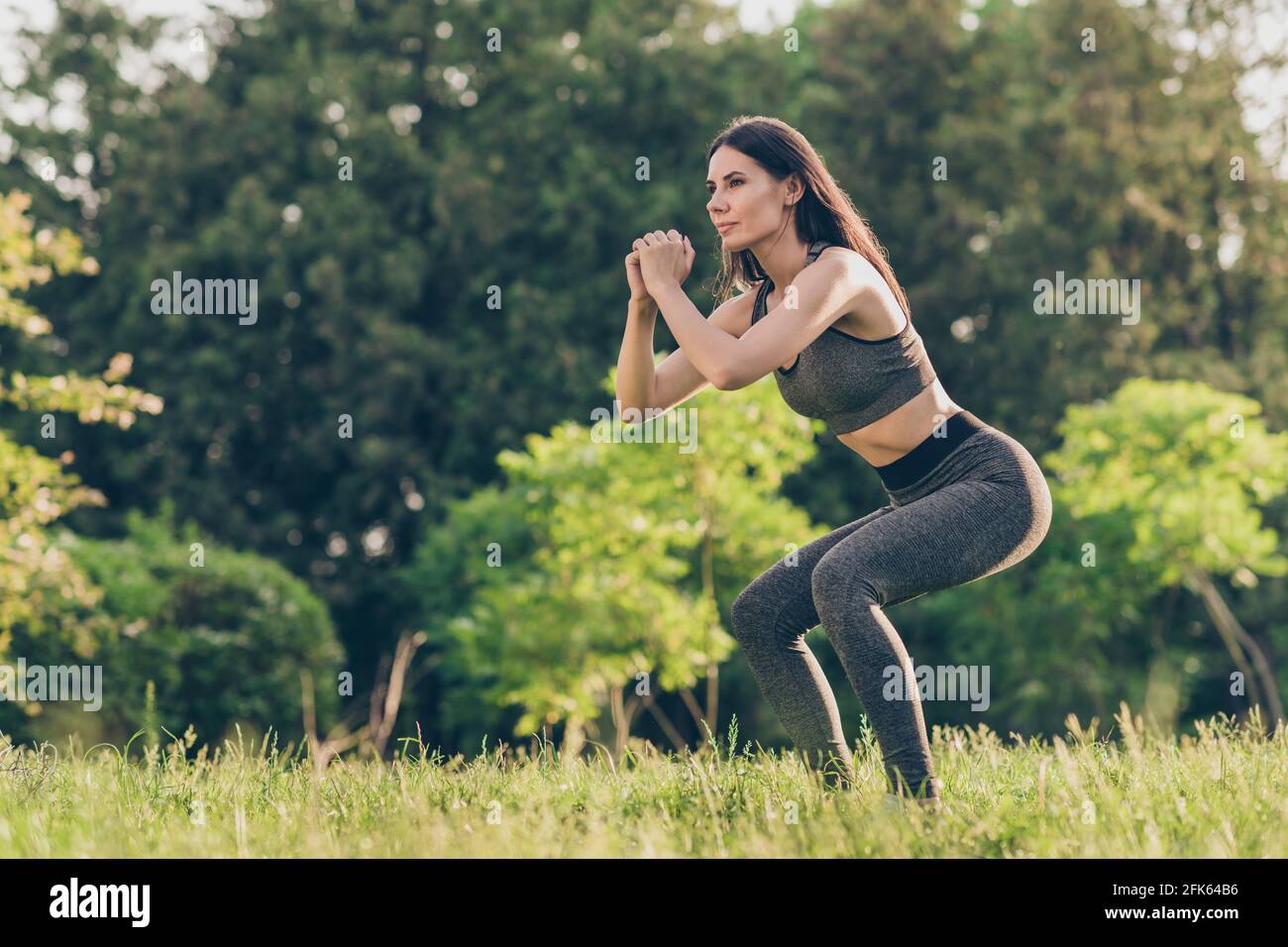 Full size profile photo of pretty girl doing squats look far away enjoy ...