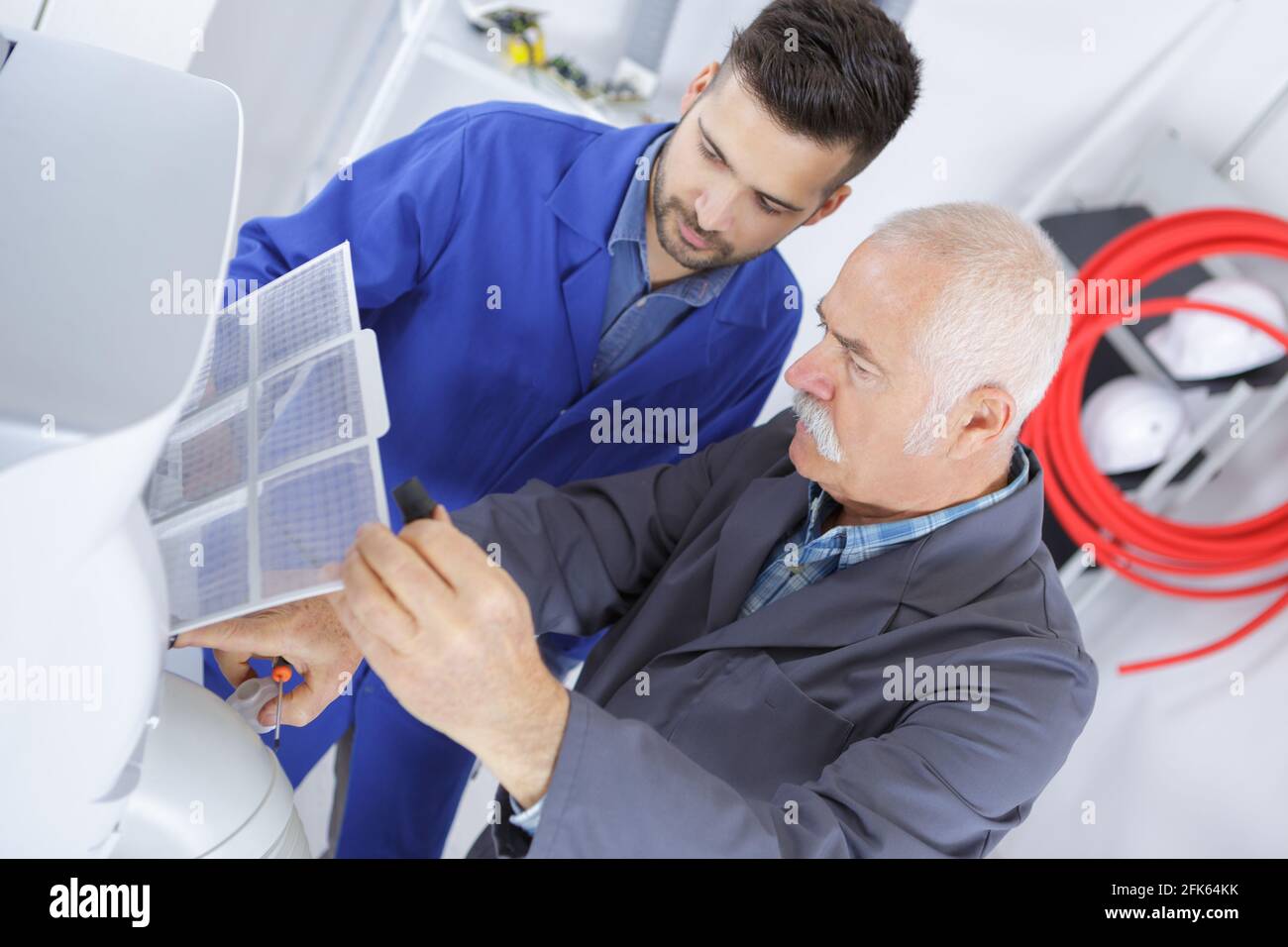 electrician fixing electrical devices with different tools Stock Photo ...