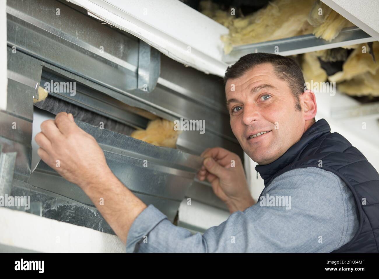 worker reinforcing a window indoors Stock Photo - Alamy