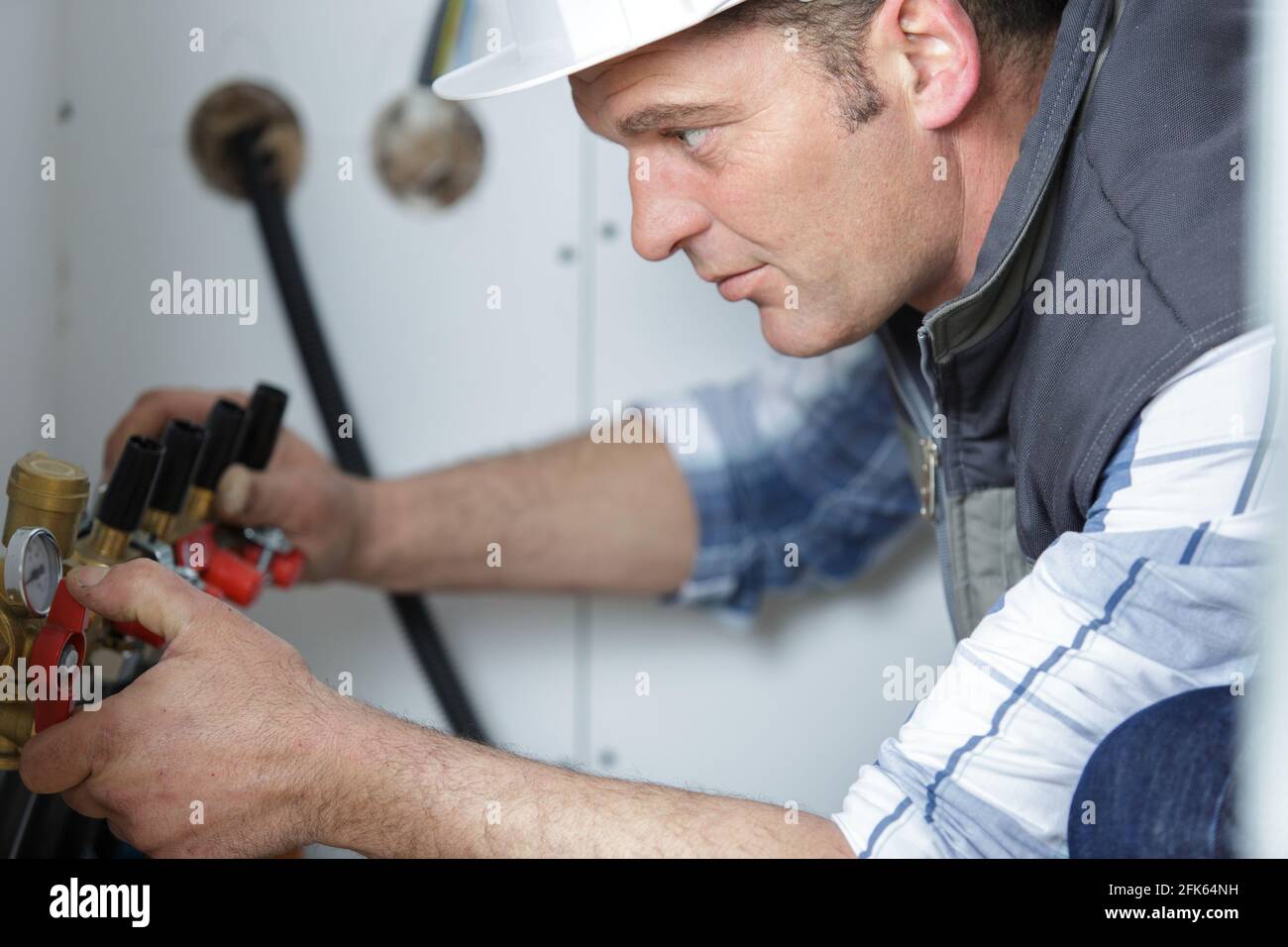 male plumber reading the water meter Stock Photo - Alamy