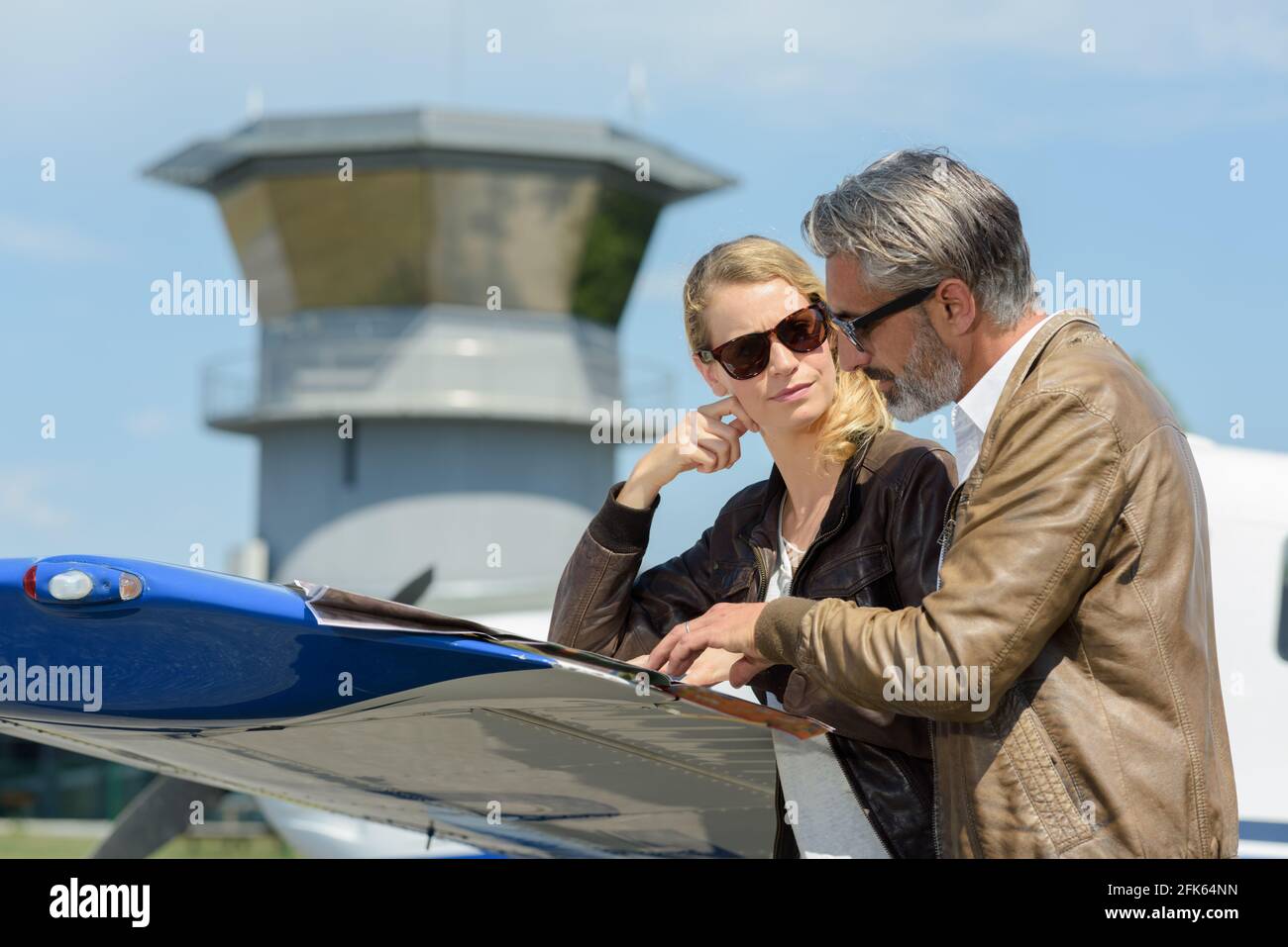female air traffic control tower worker with manager outdoors Stock ...
