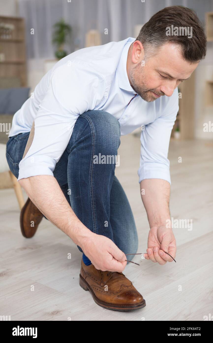 Business man tying shoelaces on hi-res stock photography and images - Alamy