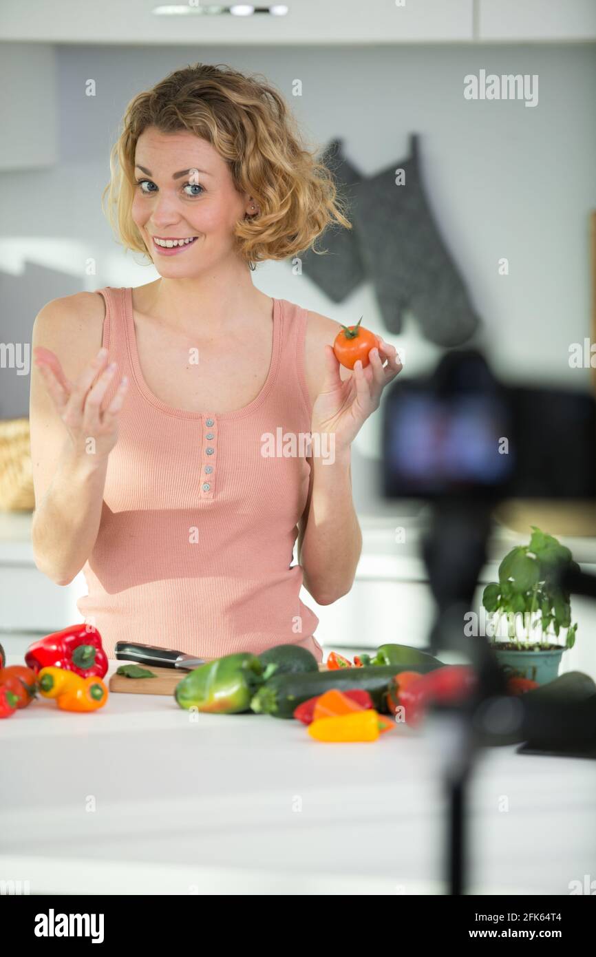 female vlogger recording cooking related broadcast at home Stock Photo ...