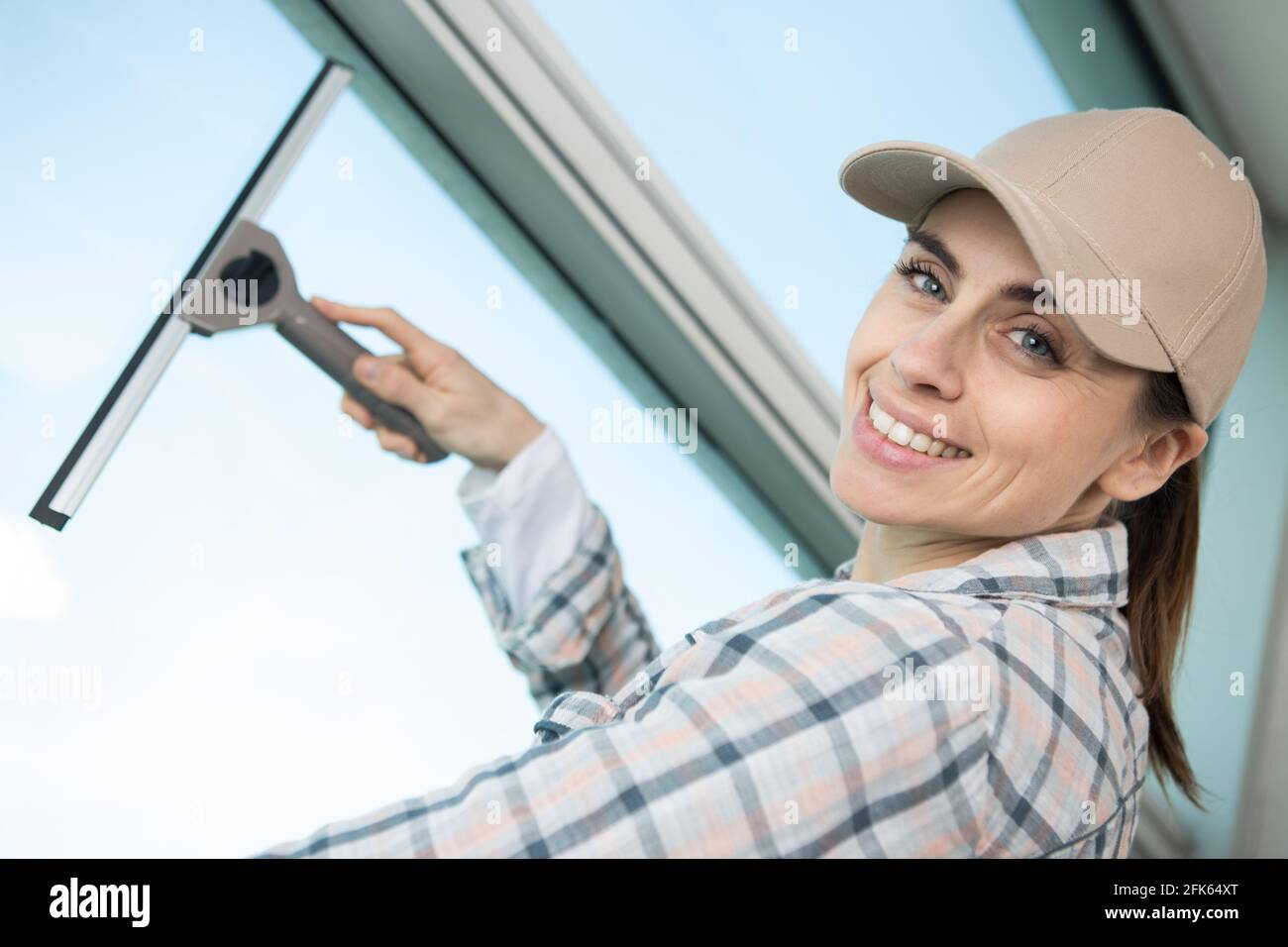 woman cleaning windows with a squeegee Stock Photo - Alamy