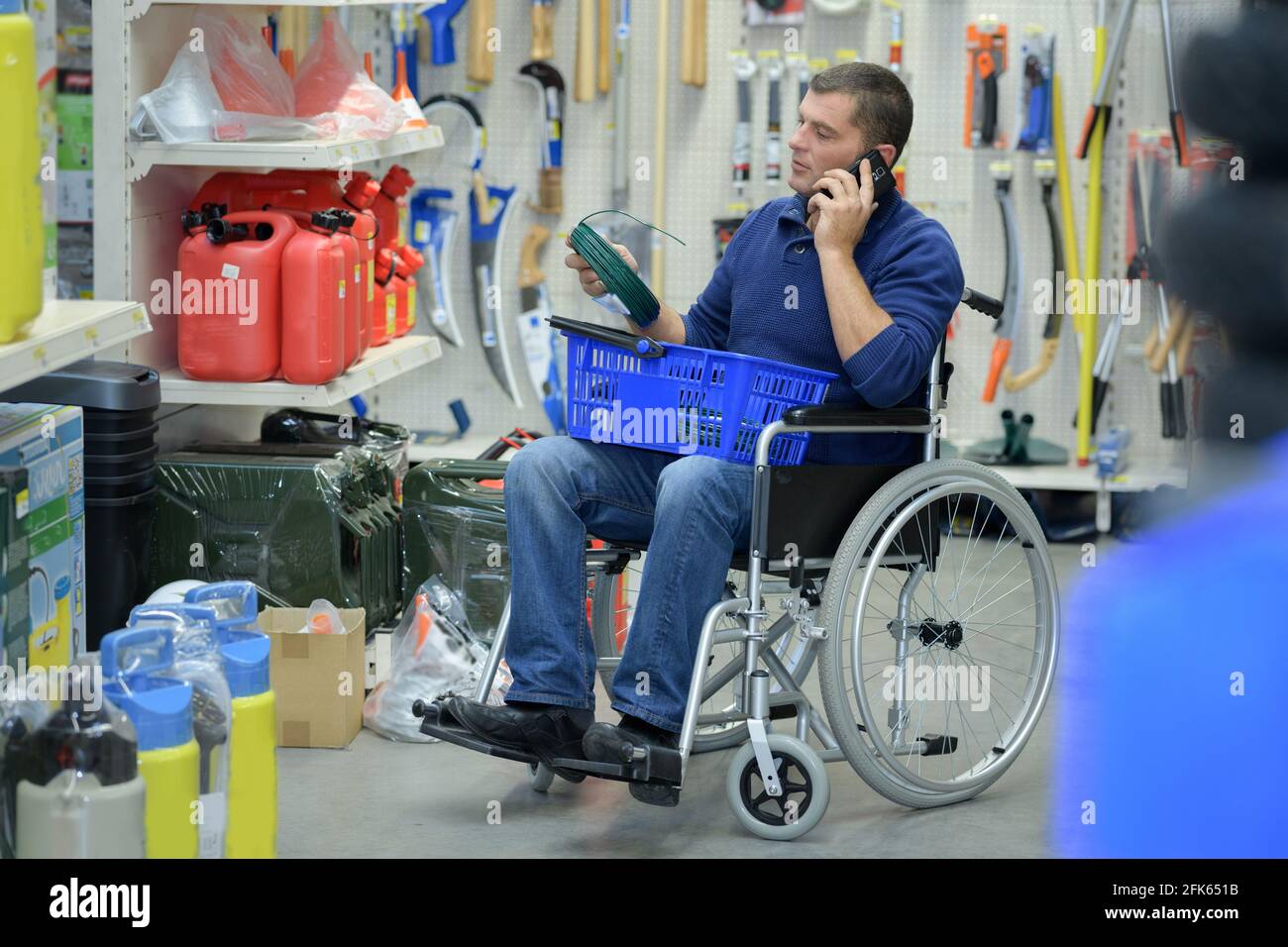 man in wheelchair shopping in hardware store Stock Photo - Alamy