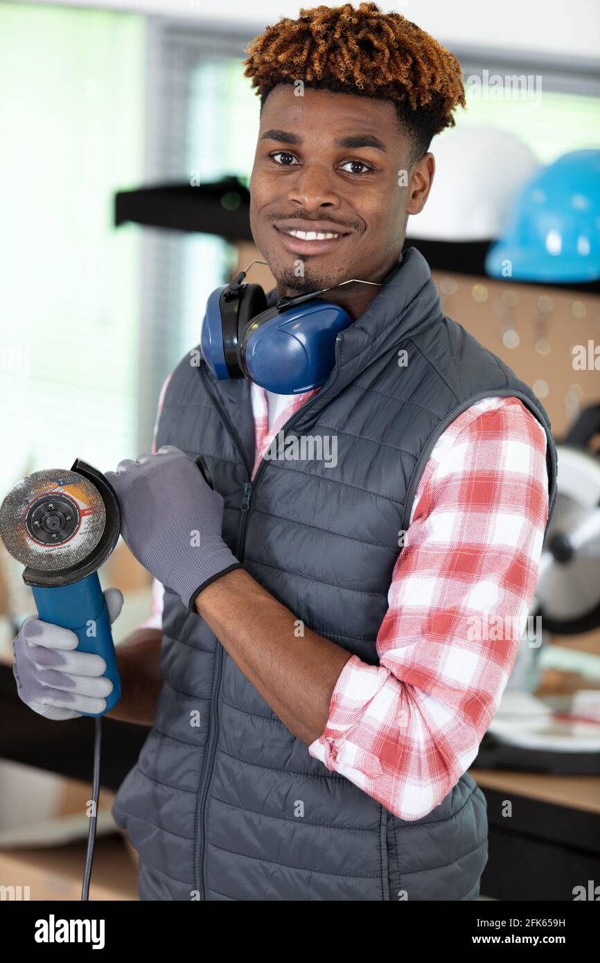 man posing with an angle grinder in his hands Stock Photo - Alamy