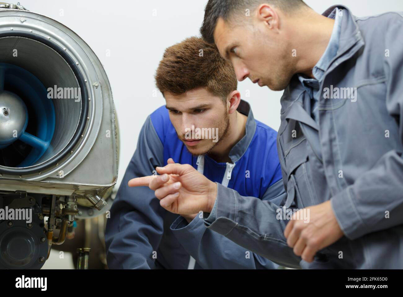airplane service team repairing plane in hangar Stock Photo - Alamy
