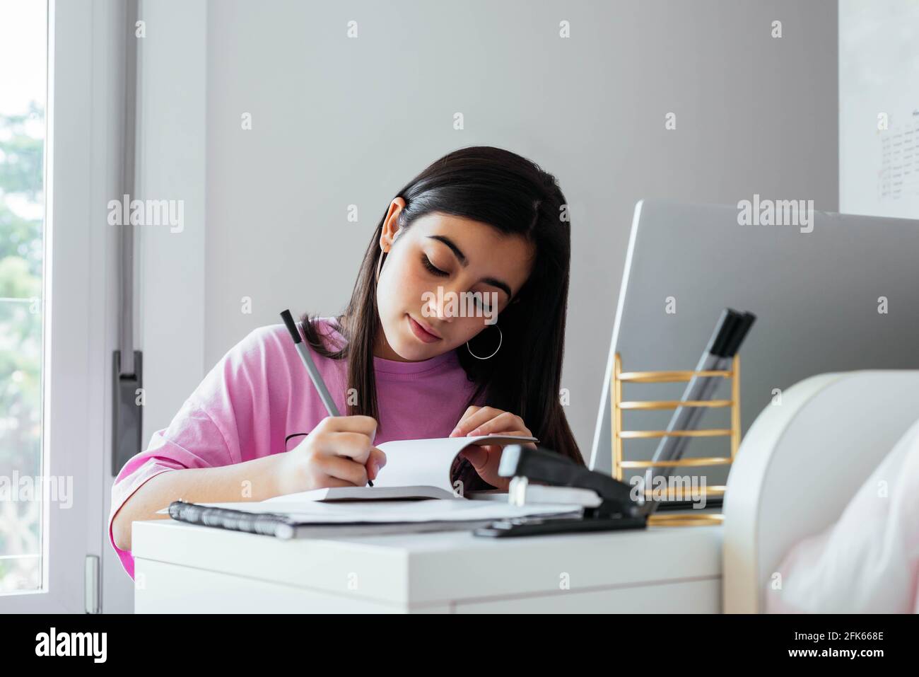 Focused teen studying at desktop in personal room Stock Photo - Alamy