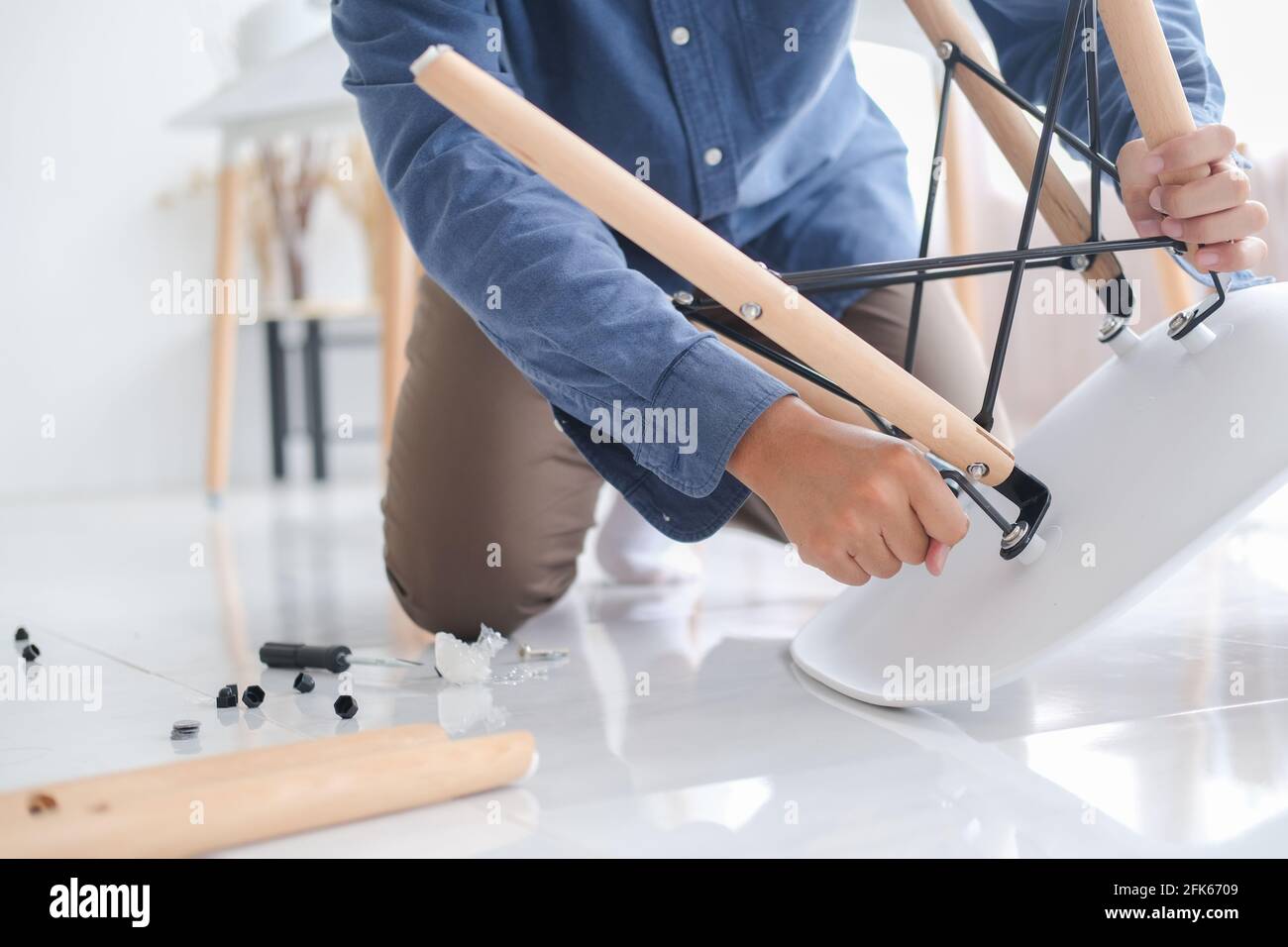 Young man doing DIY work, assembling furniture at home Stock Photo - Alamy
