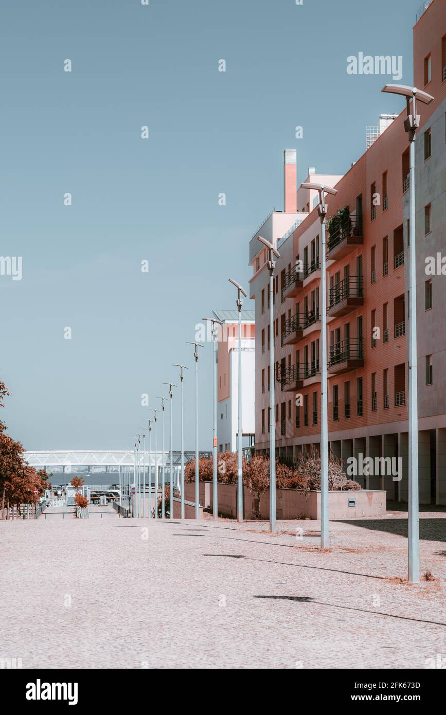 A vertical view of a city street on a sunny day with a clear blue sky ...