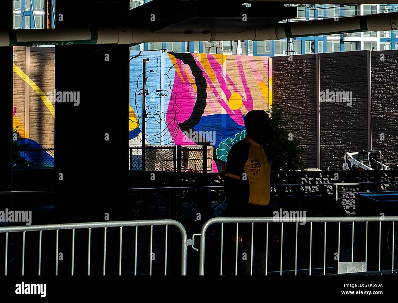 Man in deep shadows in front of a street mural Stock Photo - Alamy
