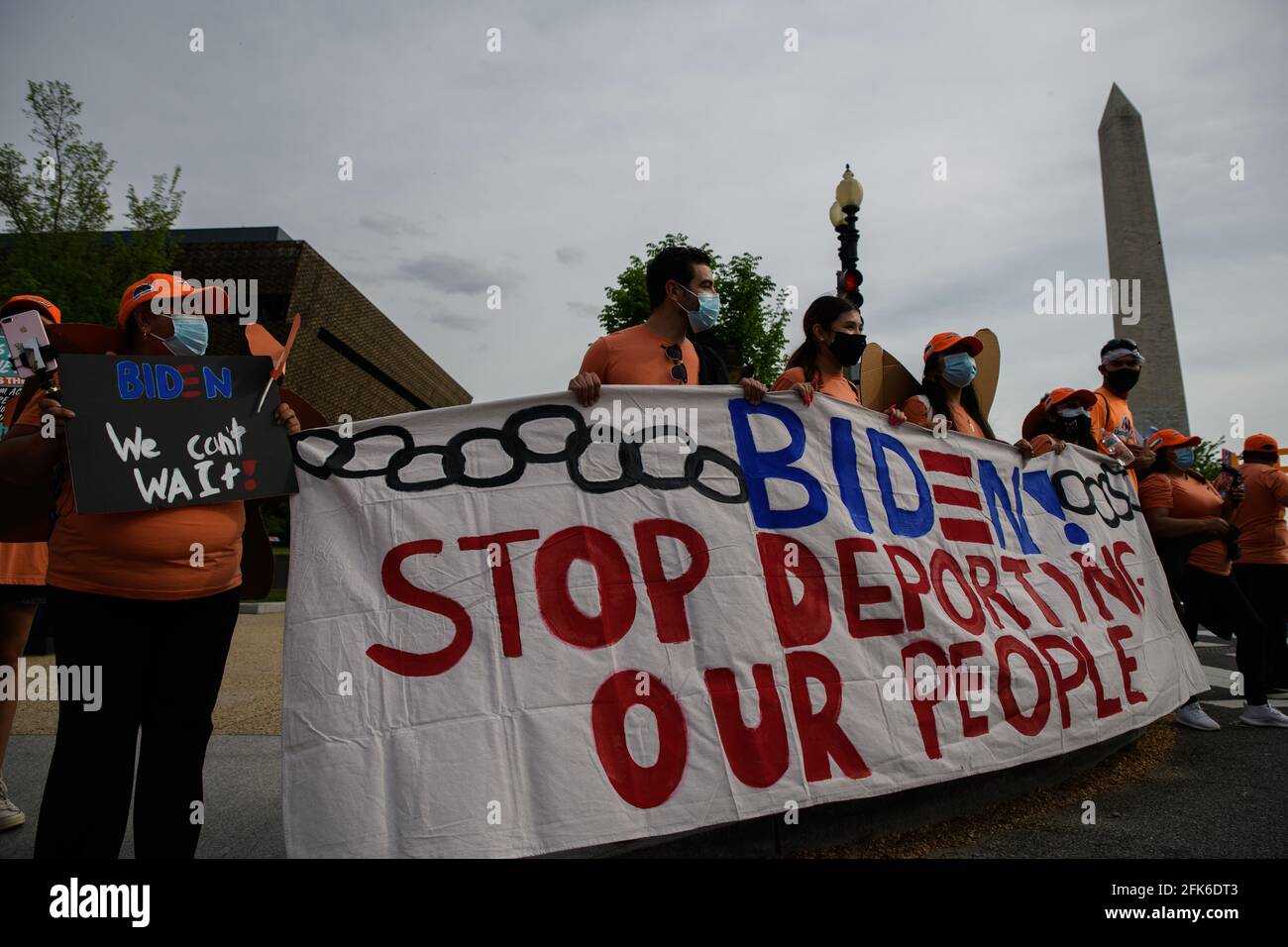 Pro-immigration activists hold a banner beneath the Washington Monument ...