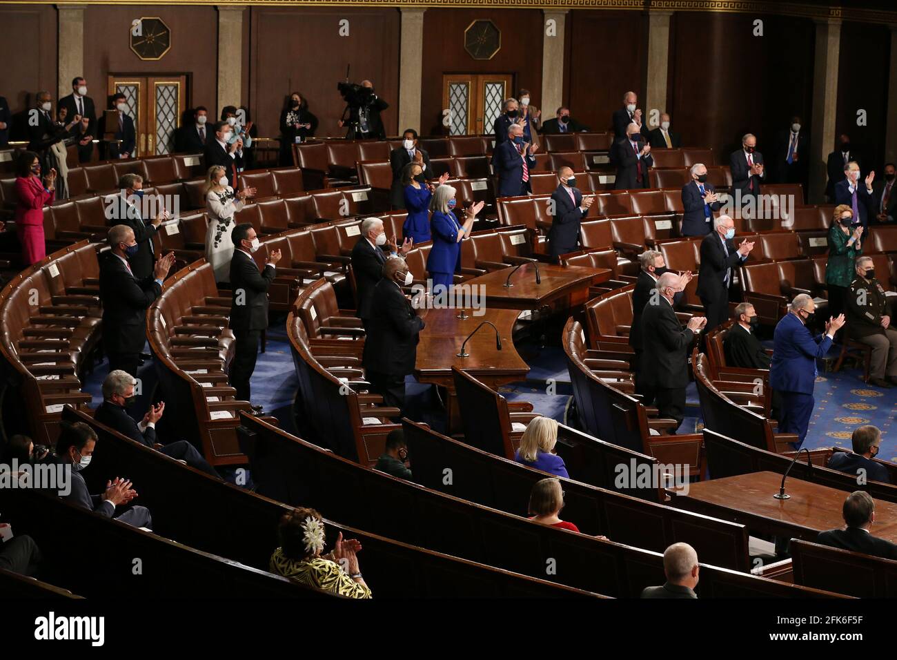 Members of the gallery stand and applaud as US President Joe Biden ...