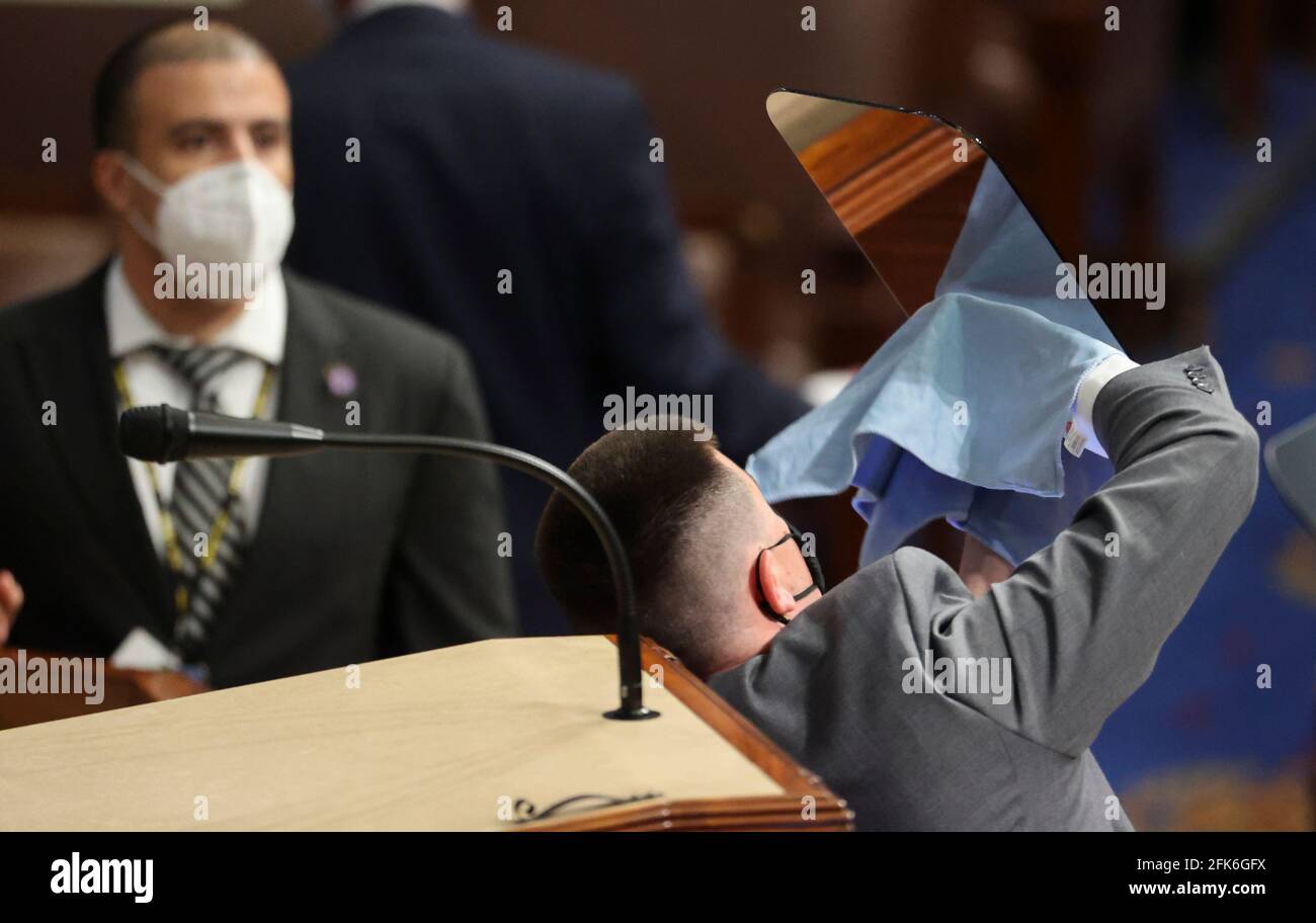 A White House staff member polishes the glass of U.S. President Joe ...