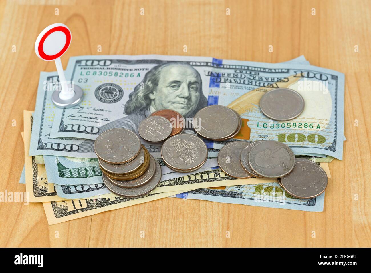Circle traffic road sign pole on American US coins banknotes on wooden ...