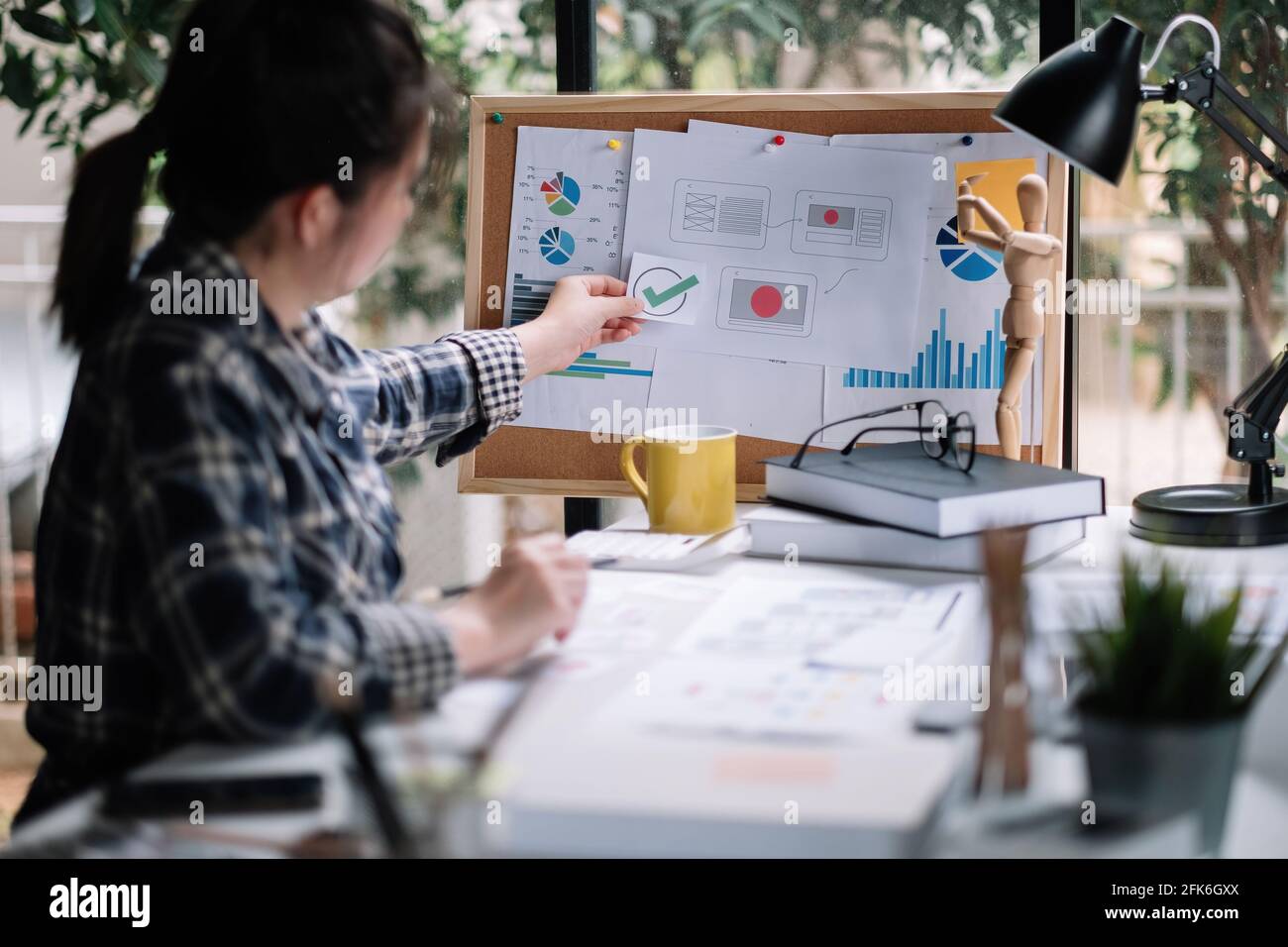 Shot of App developer Ux Ui designing with paper model on mobile ...