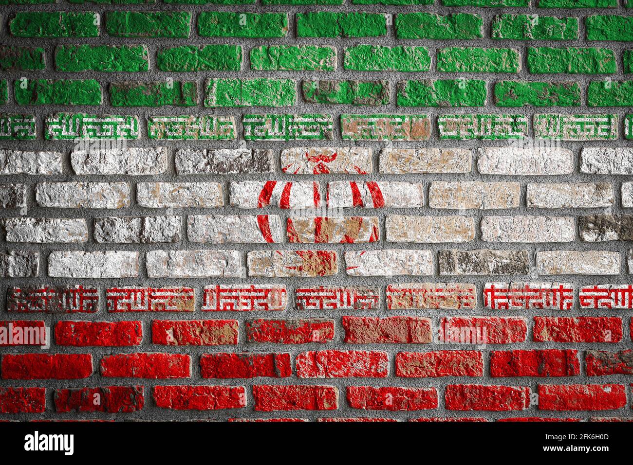 National flag of Iran depicting in paint colors on an old brick wall ...