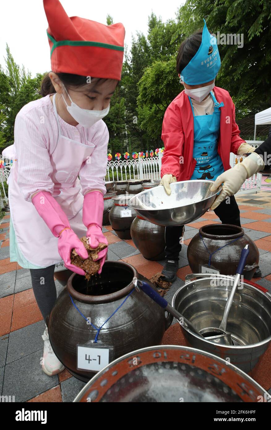 29th Apr, 2021. Making Korean soybean paste Kids take a brick of bean ...