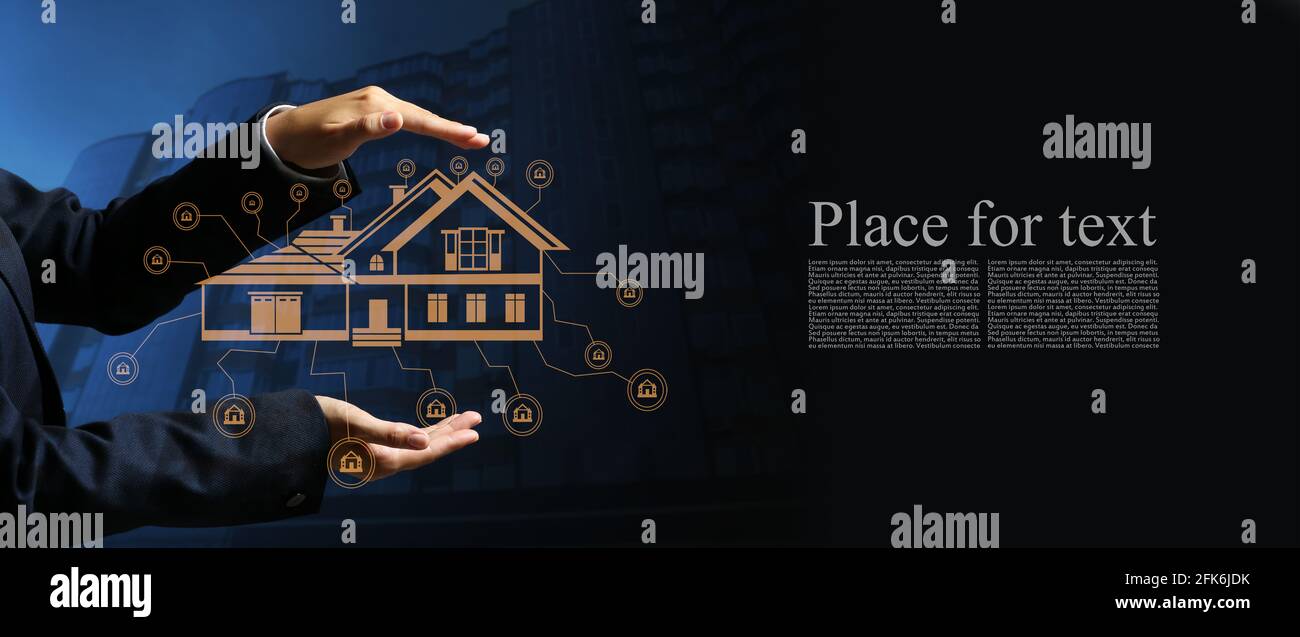 Real estate agent with digital projection of building on dark ...