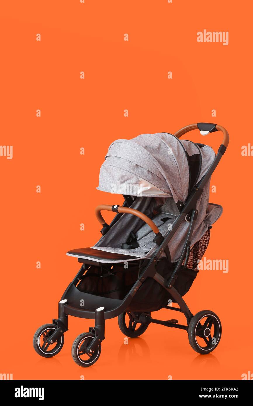 Modern baby stroller on color background Stock Photo - Alamy
