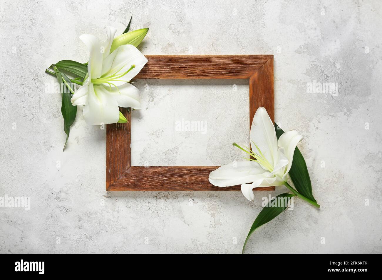 Beautiful lily flowers and frame on light background Stock Photo - Alamy