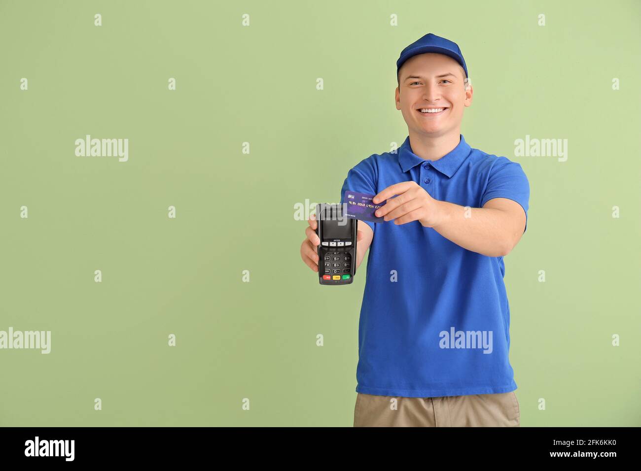 Courier with payment terminal on color background Stock Photo - Alamy