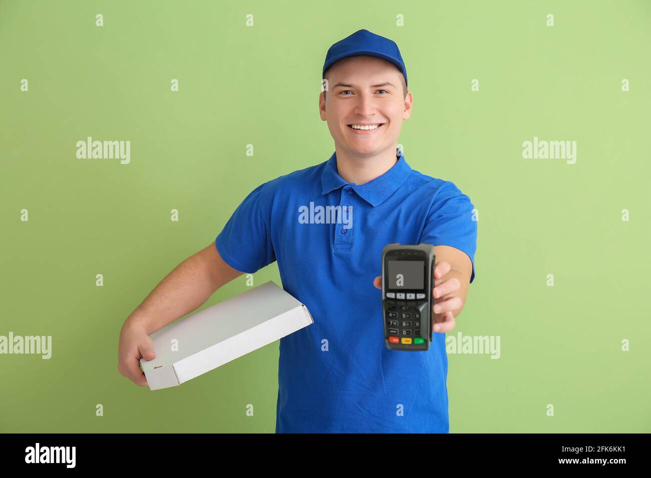 Courier of food delivery service with payment terminal on color ...