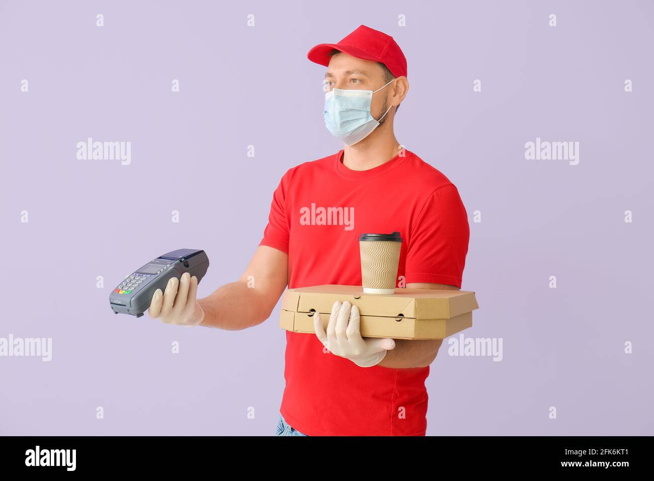 Courier of food delivery service with payment terminal on color ...