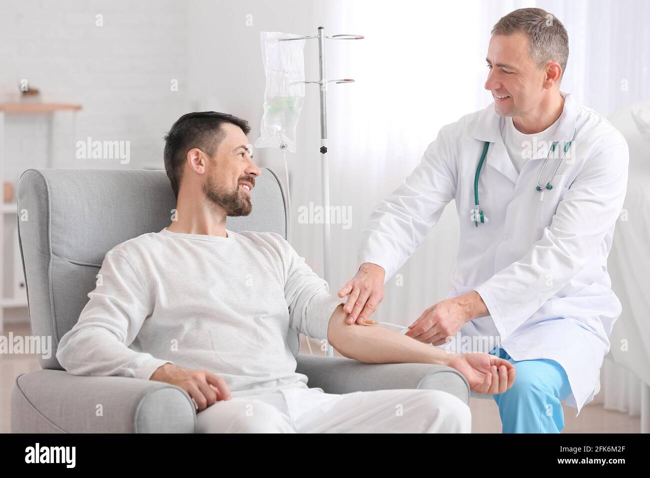 Doctor and man undergoing course of chemotherapy in clinic. Prostate ...
