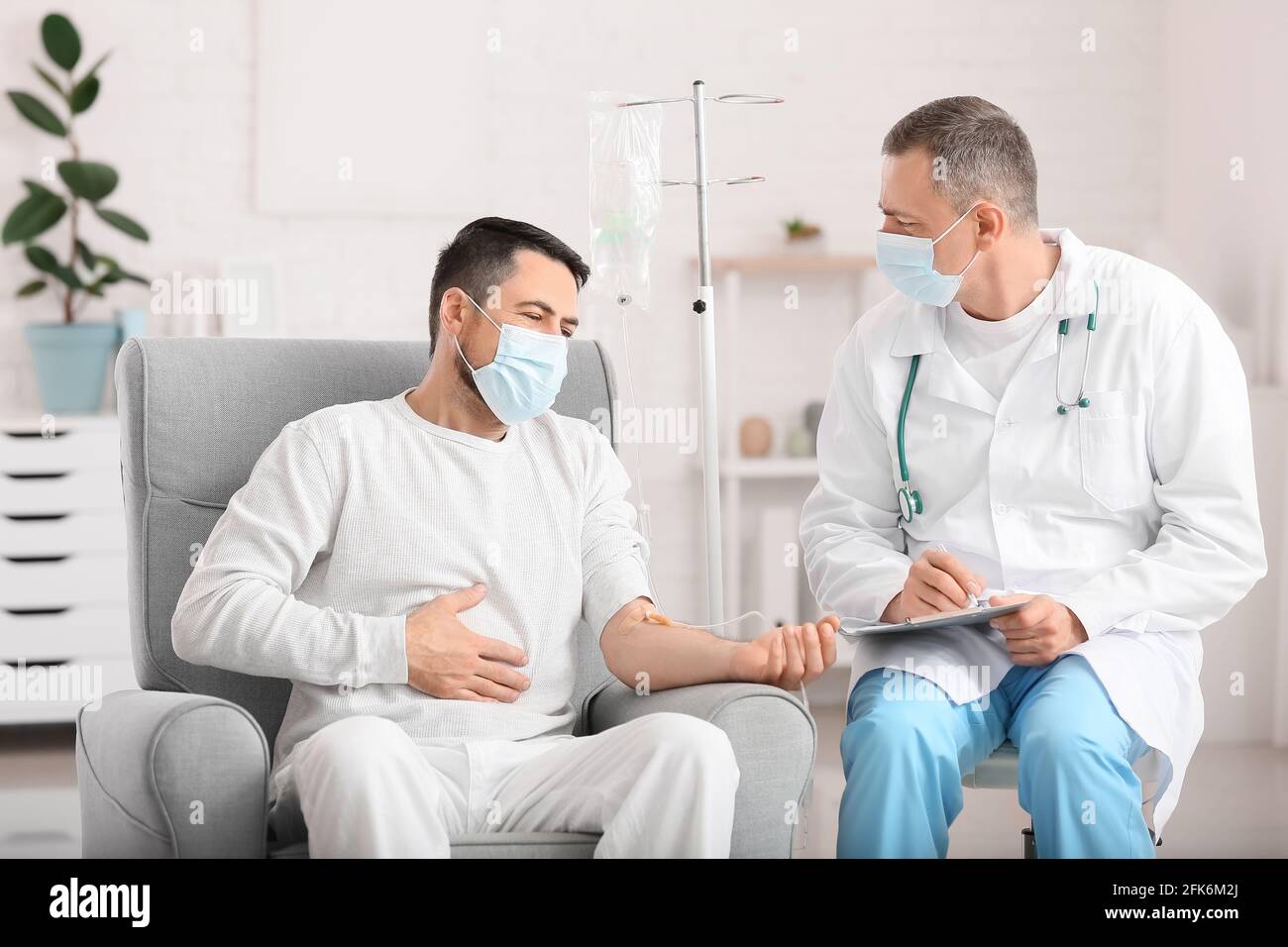 Doctor and man undergoing course of chemotherapy in clinic. Prostate ...