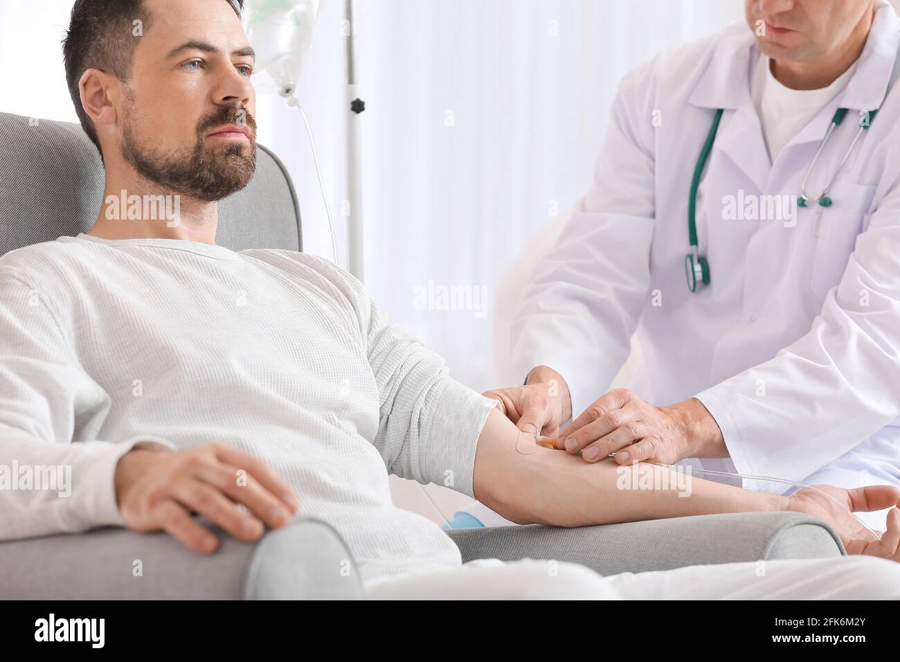 Doctor and man undergoing course of chemotherapy in clinic. Prostate ...