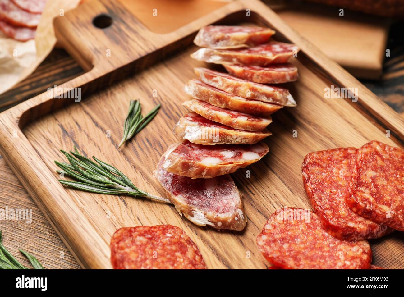 Different slices of salami on board Stock Photo - Alamy