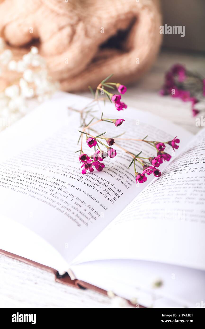 Book with fresh flowers on table, closeup Stock Photo - Alamy