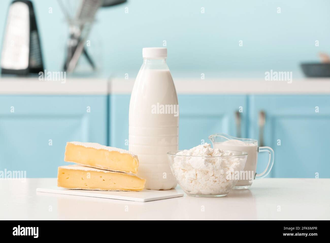 Different dairy products on table in kitchen Stock Photo - Alamy