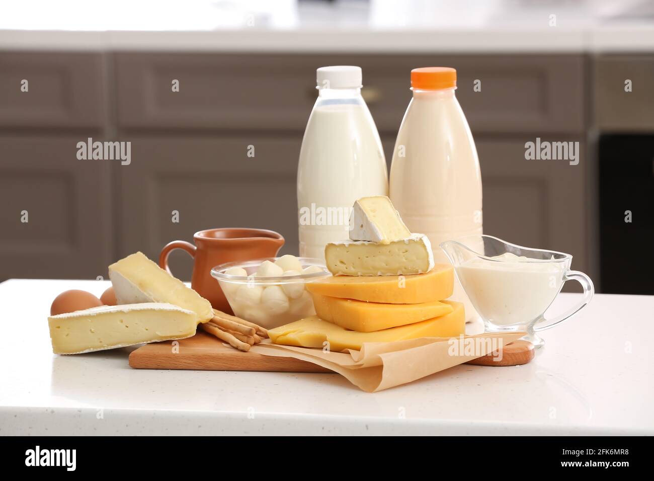 Different dairy products on table in kitchen Stock Photo - Alamy