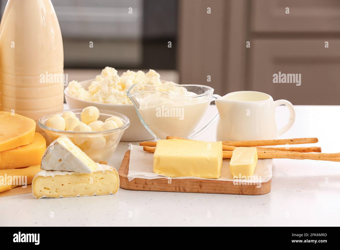 Different dairy products on table in kitchen Stock Photo - Alamy