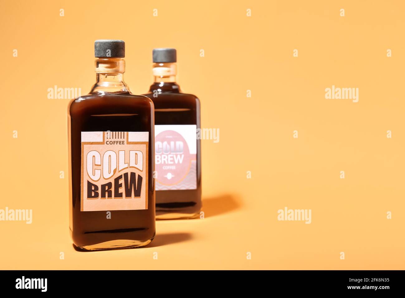 Bottles of cold brew on color background Stock Photo - Alamy