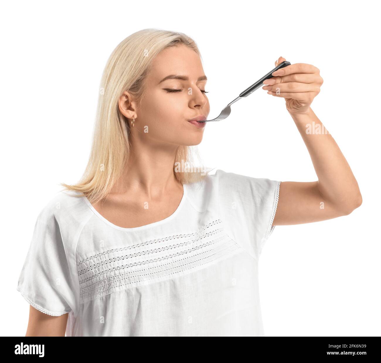 Beautiful young woman with fork on white background Stock Photo - Alamy