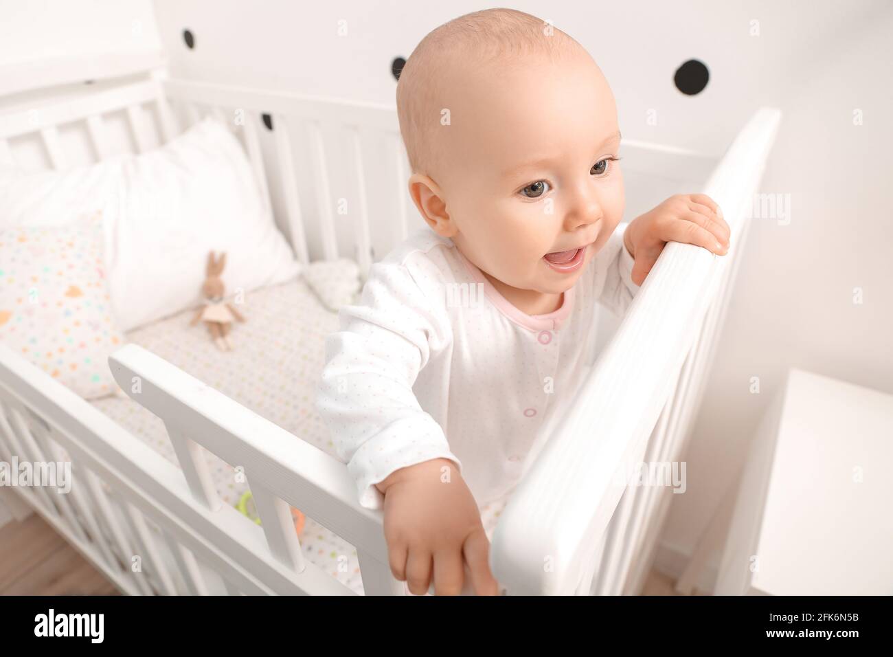 Cute little baby in crib at home Stock Photo - Alamy