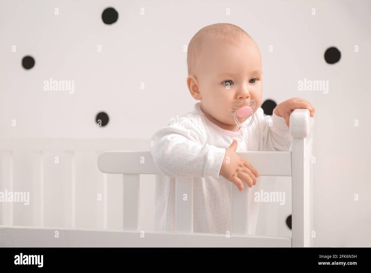 Cute little baby in crib at home Stock Photo - Alamy