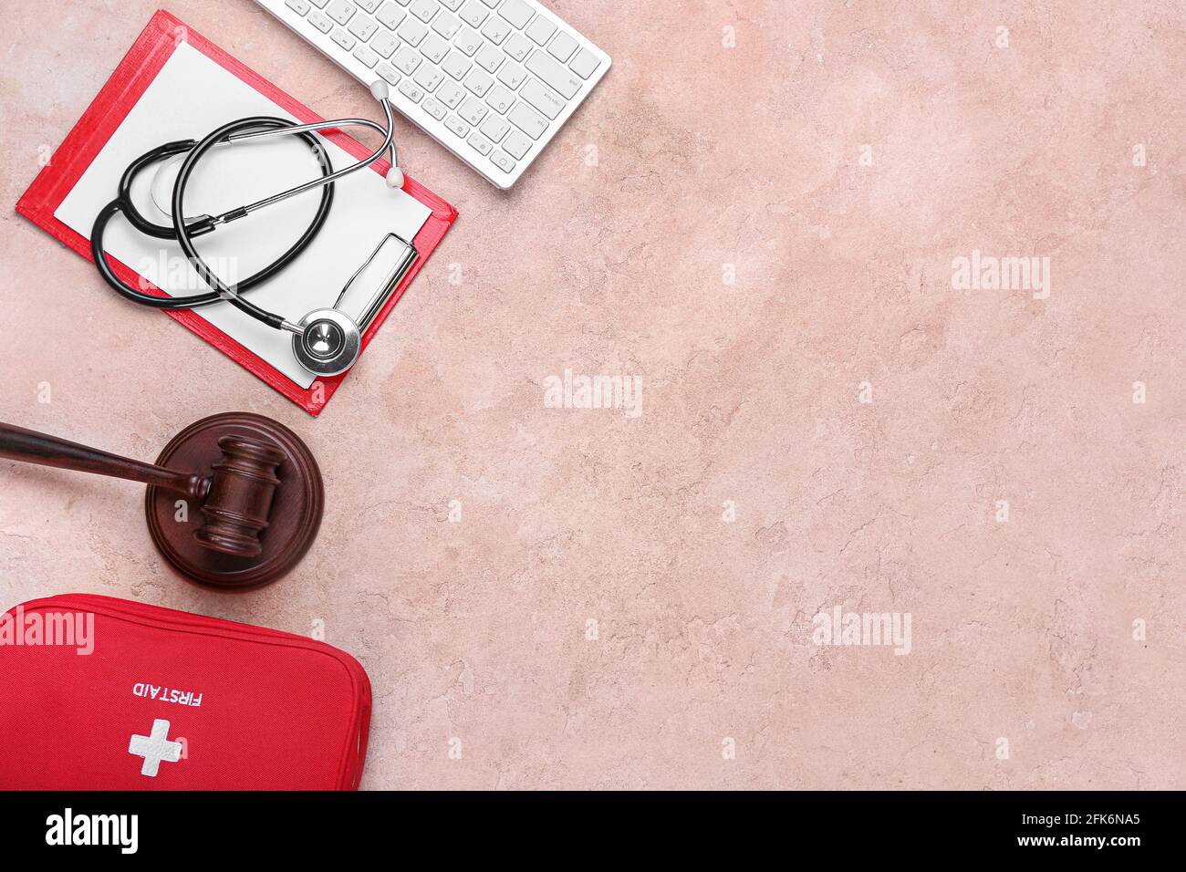 Judge gavel, PC keyboard, stethoscope, clipboard and first aid kit on ...