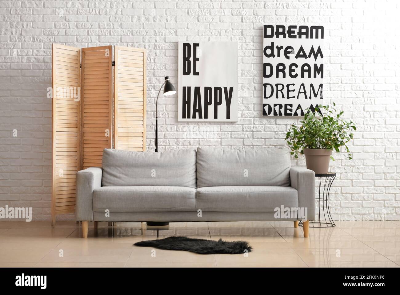 Interior of modern living room with sofa and folding screen Stock Photo ...