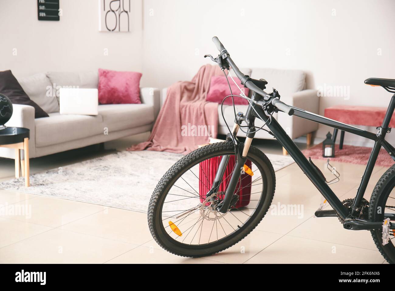Modern bicycle in interior of living room Stock Photo - Alamy