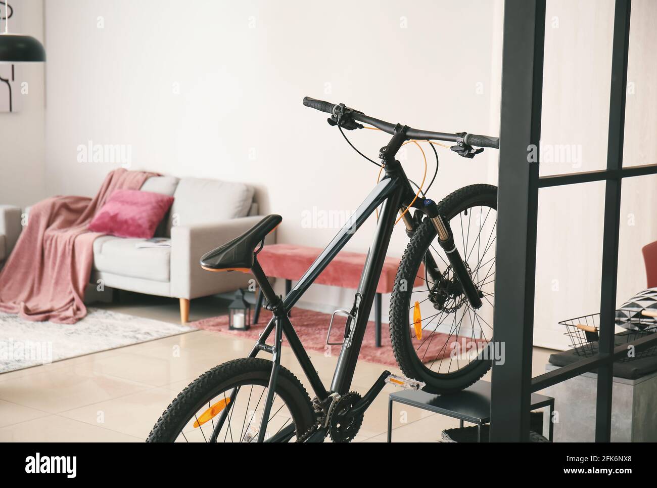 Modern bicycle in interior of living room Stock Photo - Alamy
