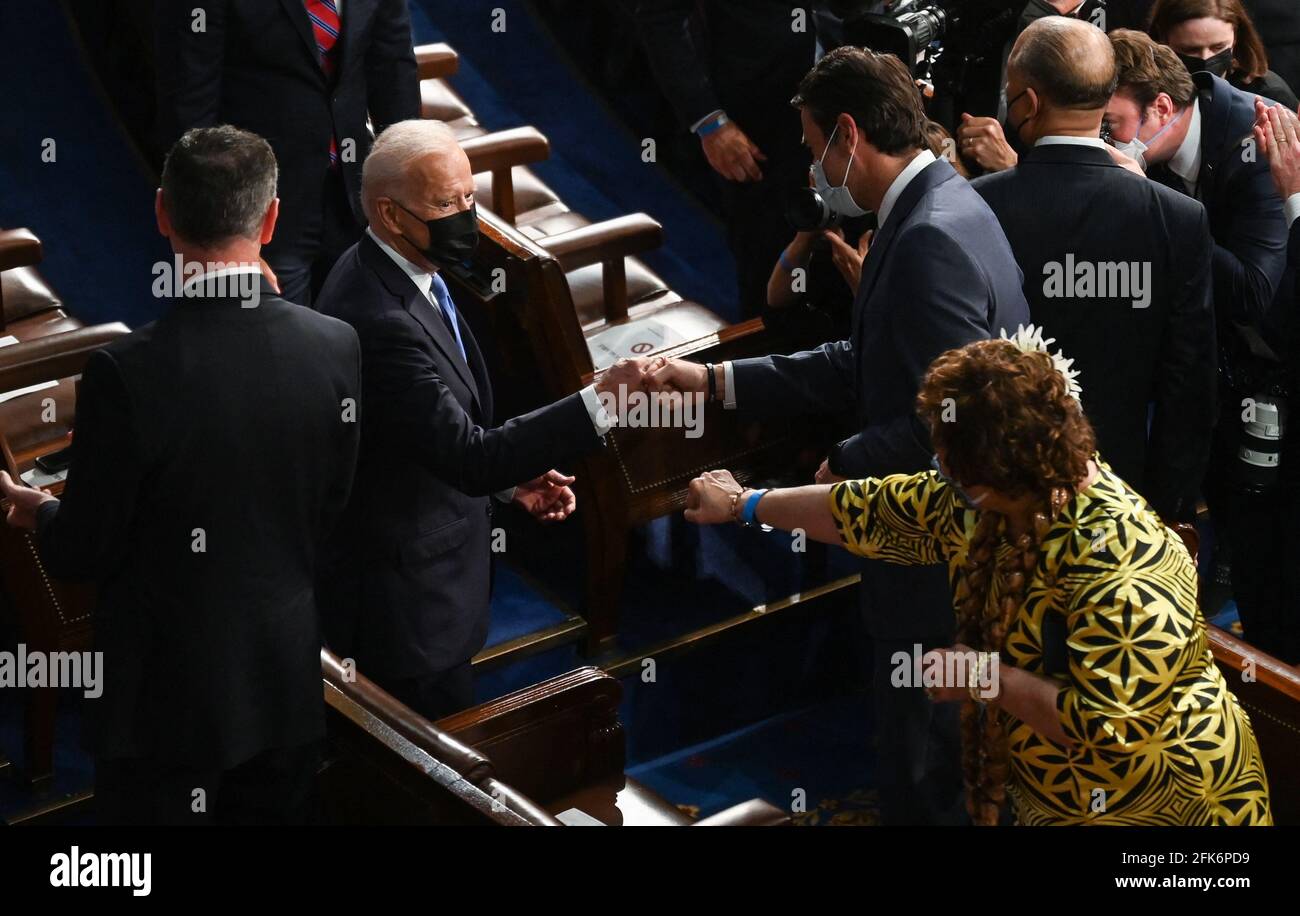 US President Joe Biden fist bumps members of Congress as he arrives to ...