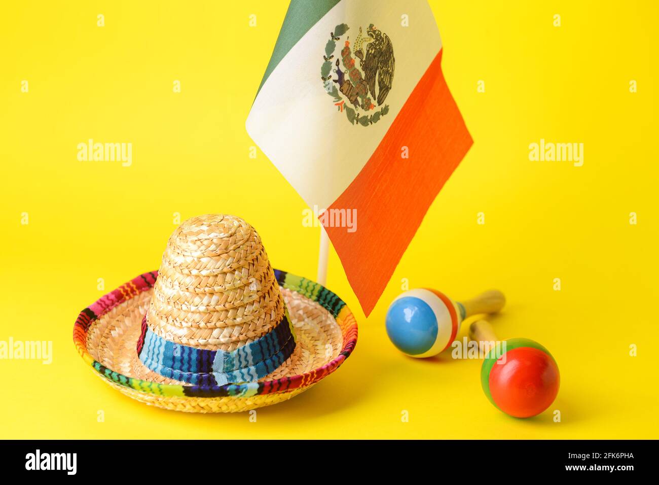 Mexican flag, maracas and sombrero hat on color background Stock Photo ...