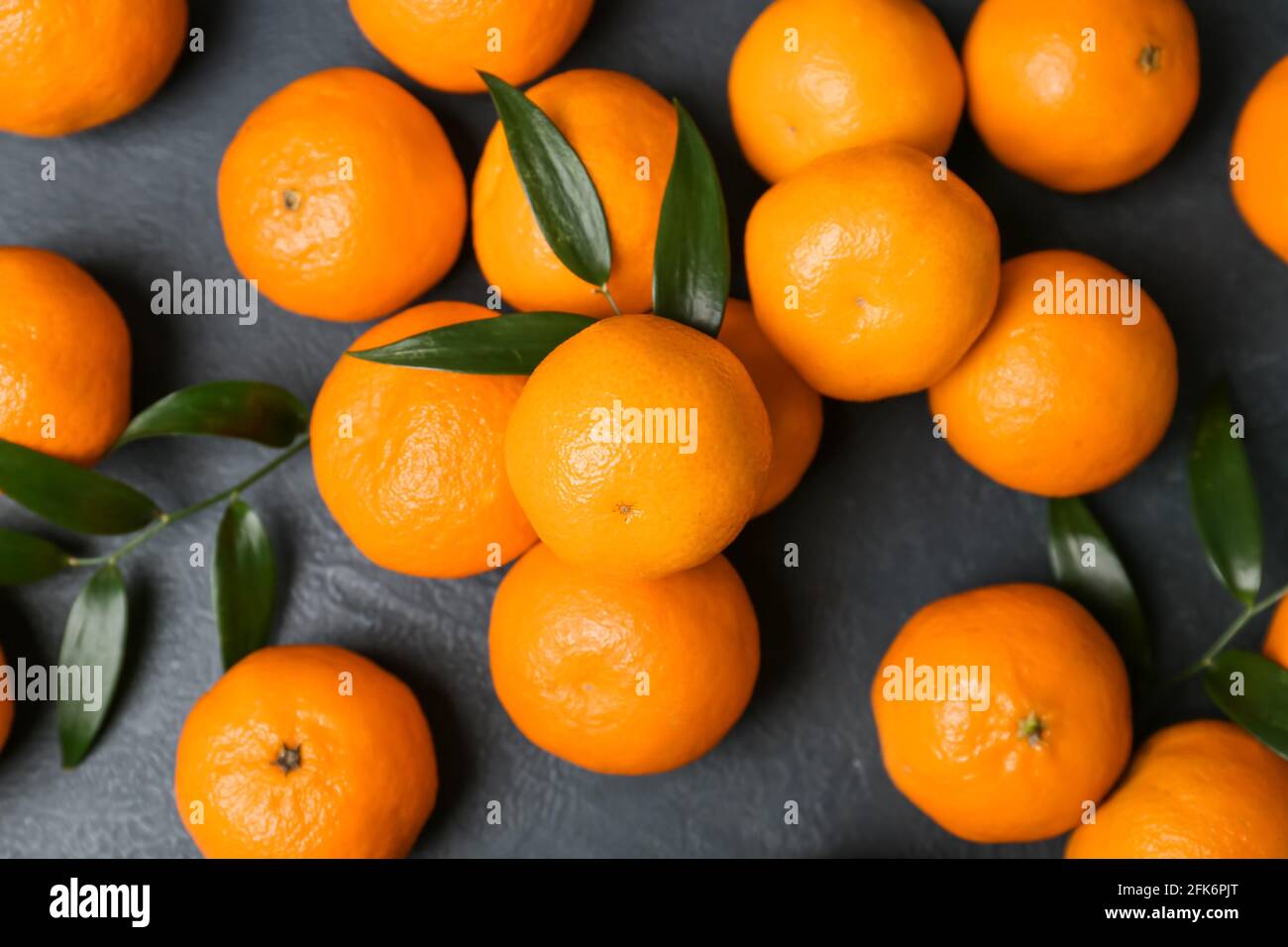 Many sweet tangerines on dark background Stock Photo - Alamy