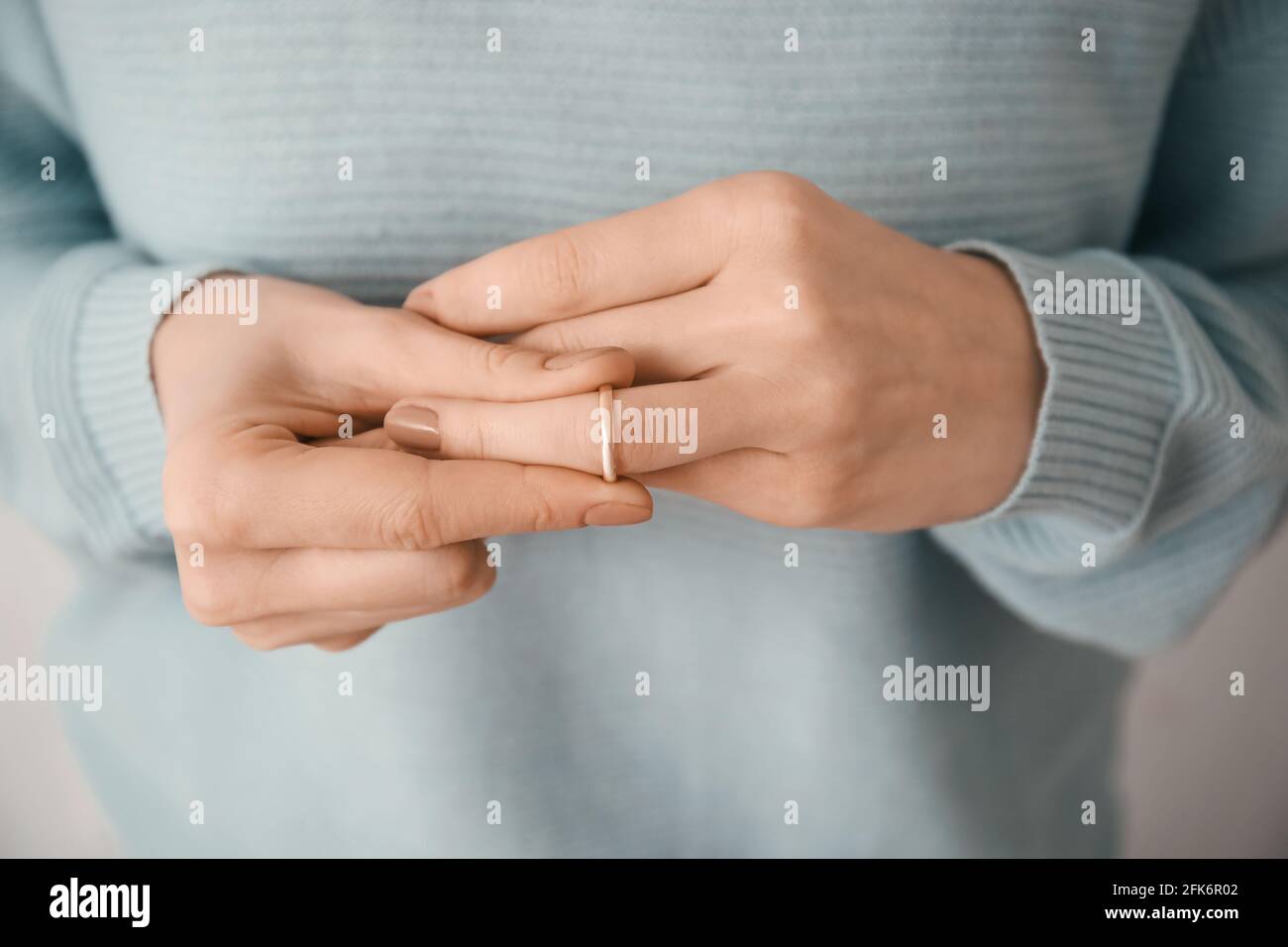 Woman taking off her wedding ring, closeup Stock Photo - Alamy