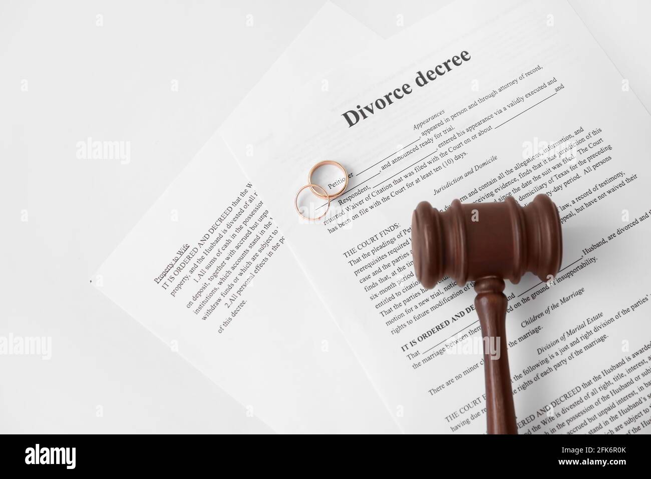 Divorce decree with judge's gavel and rings on white background Stock ...