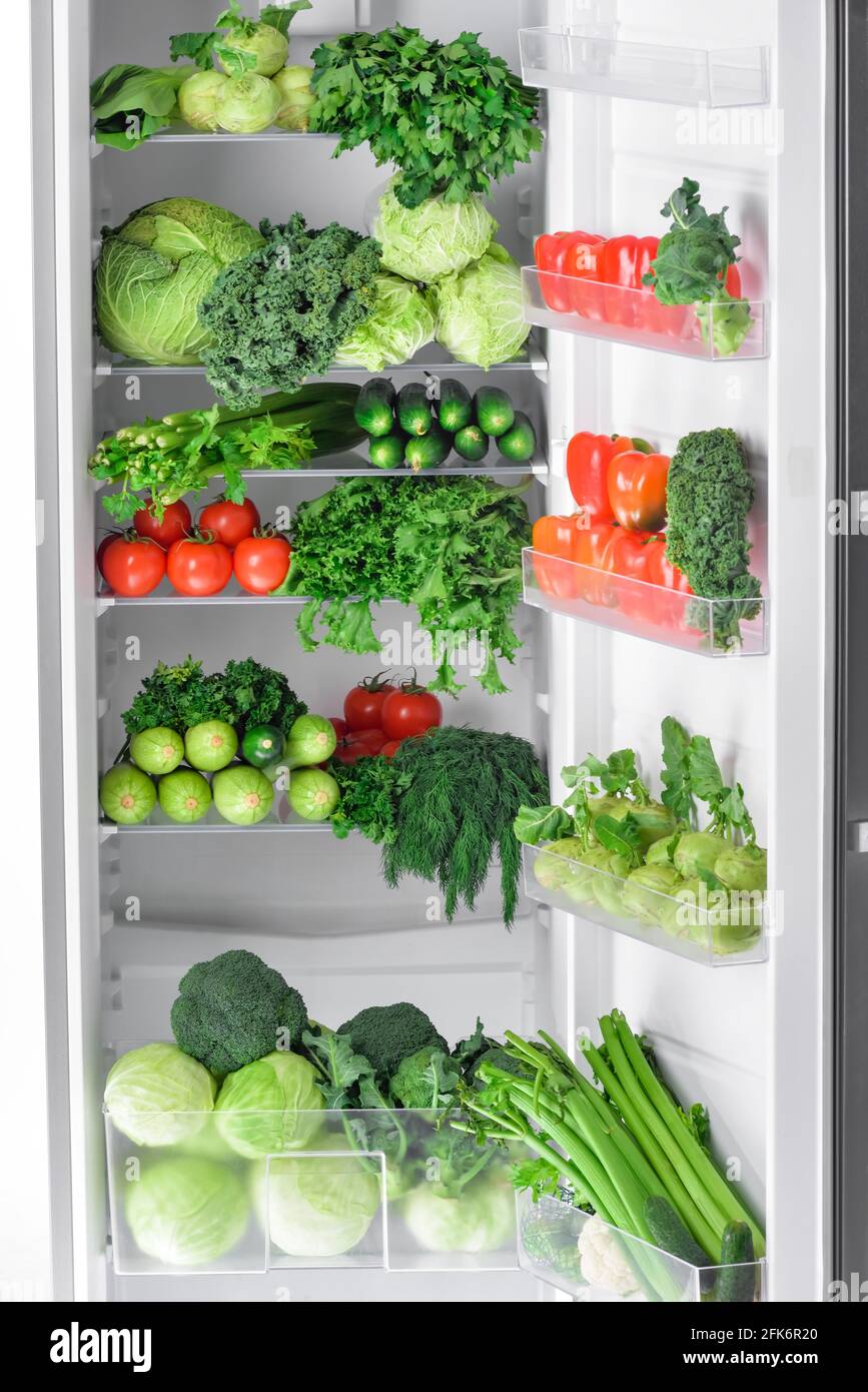 Modern fridge with fresh vegetables on white background, closeup Stock ...